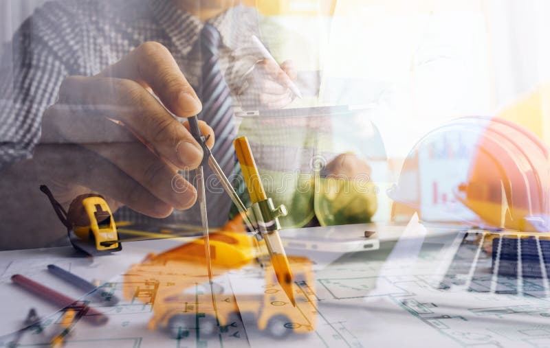 Engineer Working at a Drawings of House in Office for Discussing ...