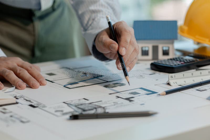 An Engineer is Working in His Office and Using Various Equipment To ...