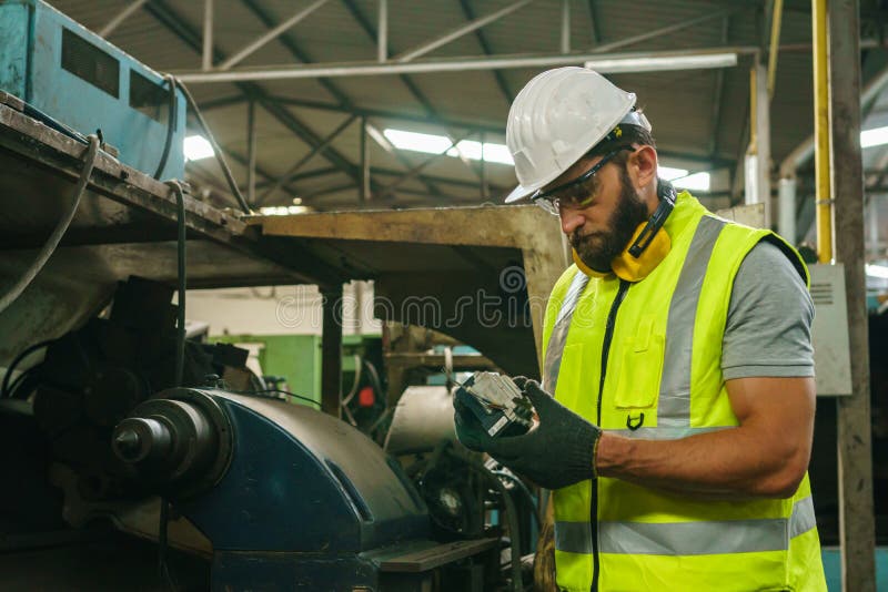 Engineer Working at Industrial Machinery in Factory. Stock Image ...