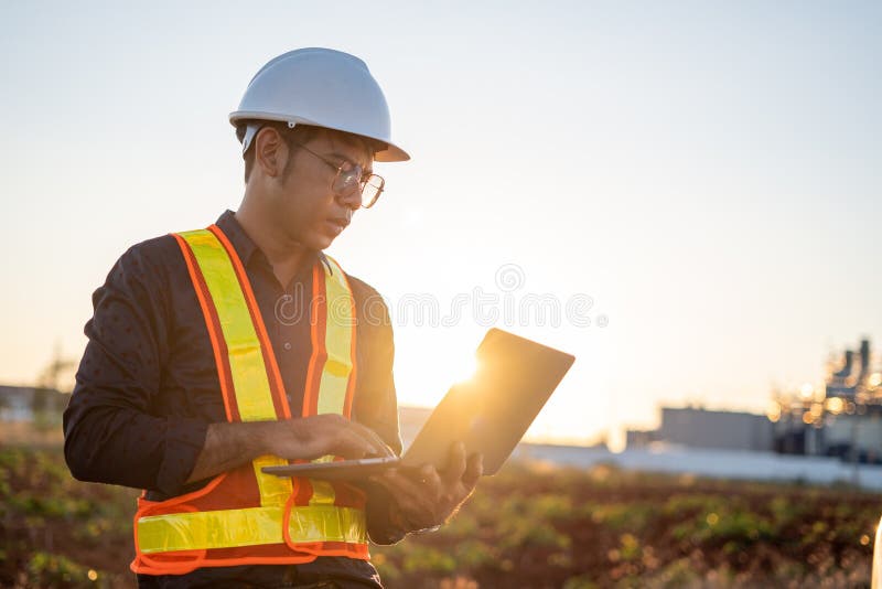 Engineer Working with Laptop at Construction Site on Sunset Stock Image ...