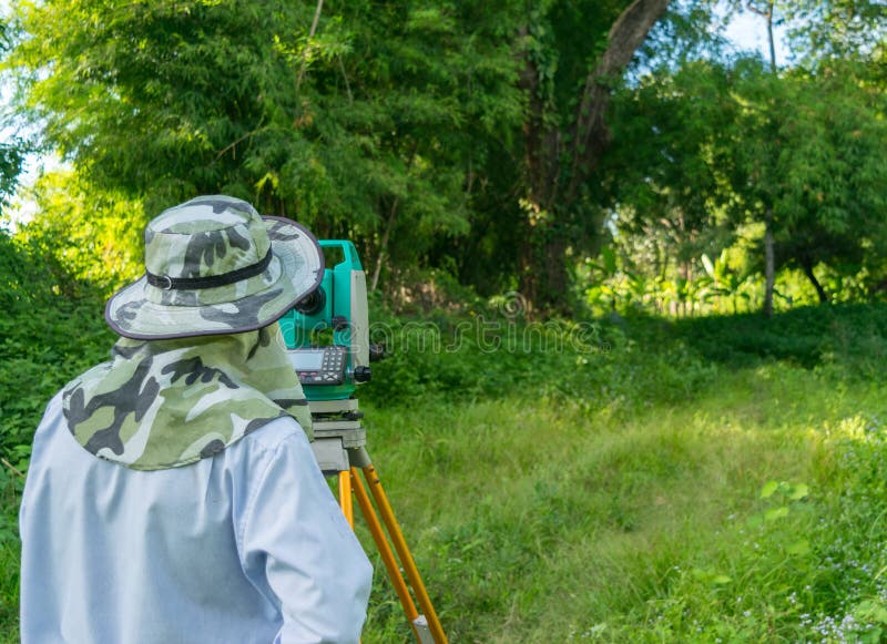 Engineer is Working with Level-measuring Instrument for Survey Stock ...