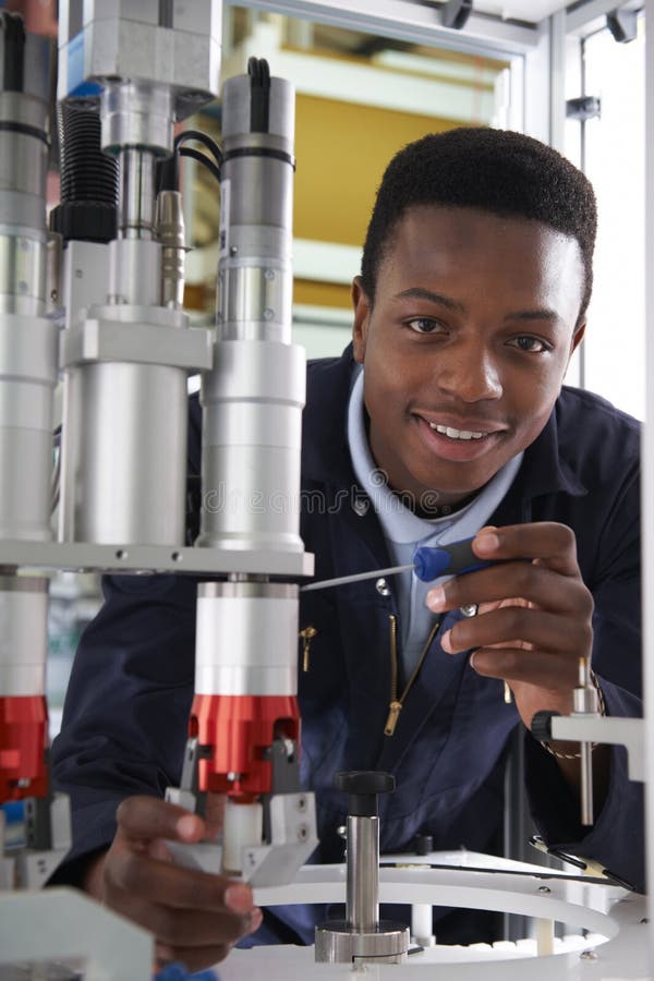 Engineer and Apprentice Working on Machine in Factory Stock Image ...