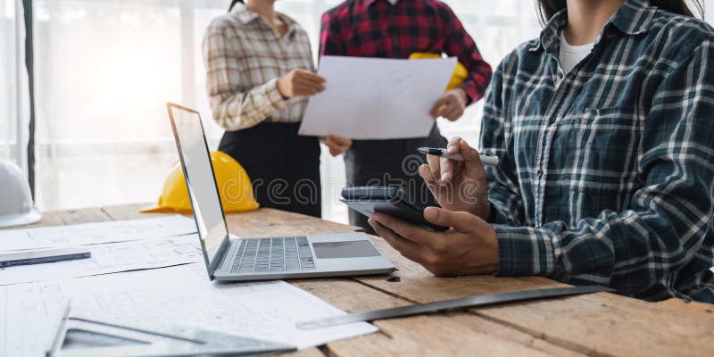 Engineer Working in Office, Engineer and Architect Use Calculator for ...