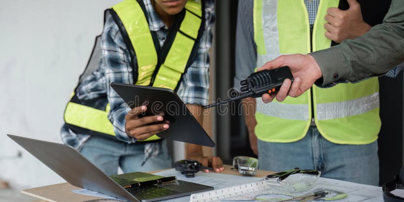 Engineer Working in Office with Blueprints , Walkie Talkie, Tablet ...