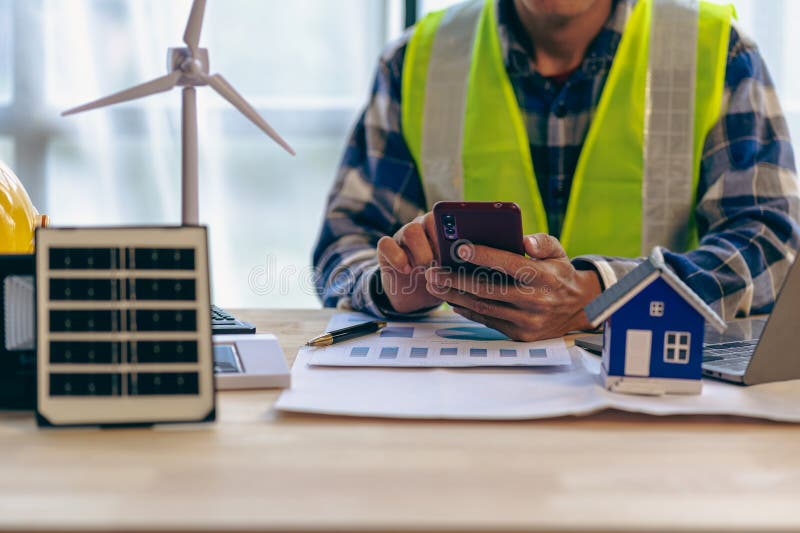 Engineer Working in Office at Desk with Solar Laptop and Concept Home ...