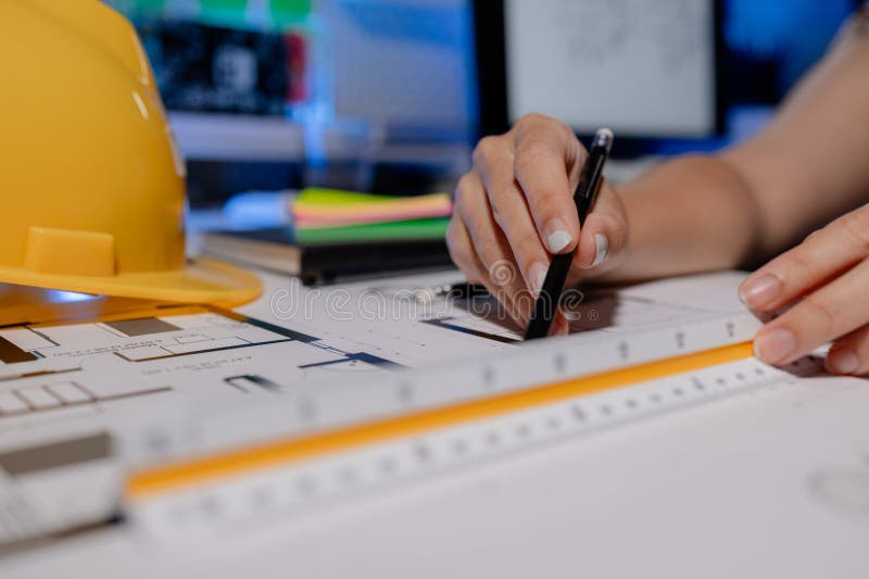 An Engineer is Working in a Private Office with Documents Spread Across ...