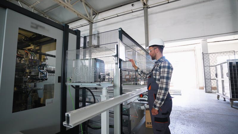 Engineer Working at Programmable CNC Machine in Factory Industries ...