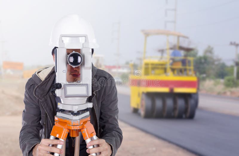 Engineer Working with Survey Equipment Theodolite with Road Under ...