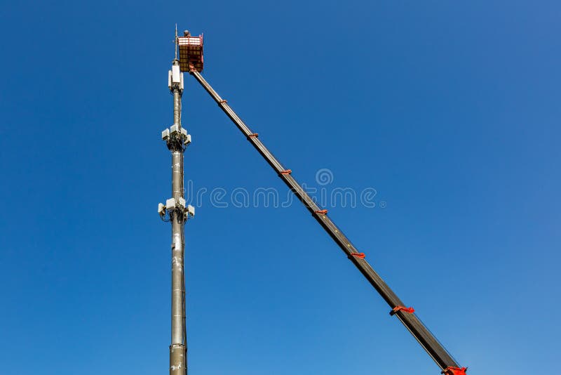 Engineer is Working on the Telecommunication Tower - Cellular Phone ...