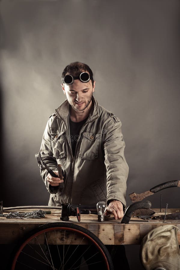 Engineer Working for a Workbench Stock Photo - Image of dark, product ...