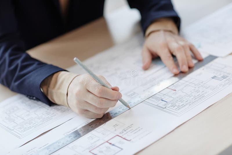 Engineer at Workstation Drawing Blueprints and Plans by Hand Holding ...