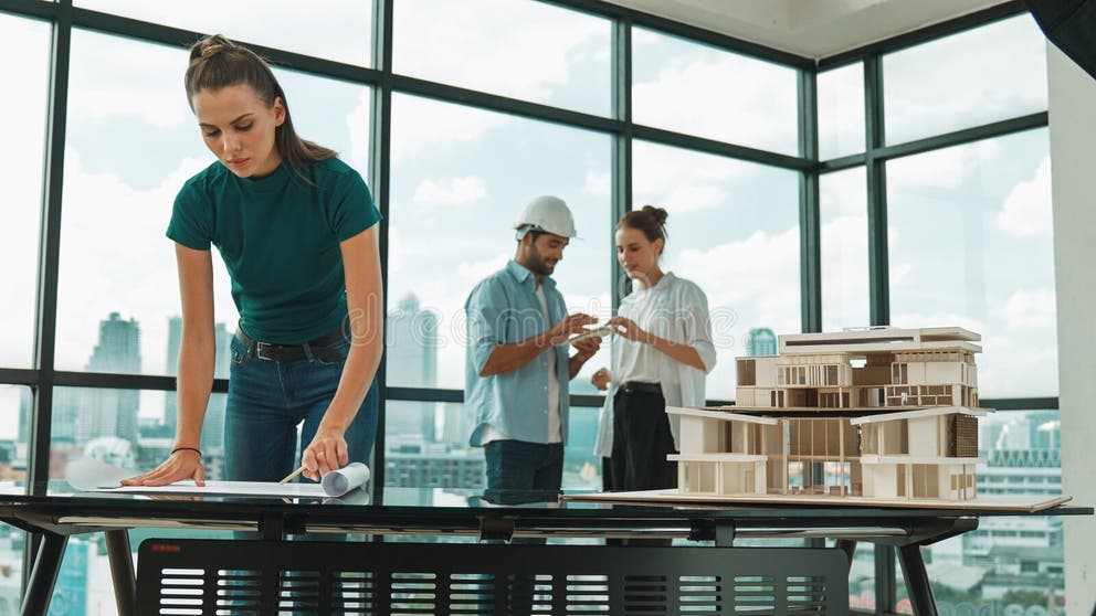 Engineer Write Project Plan while Team Discuss about House Design ...