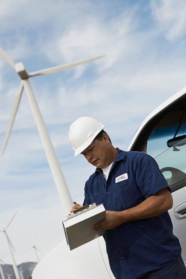 Engineer Writing on Clipboard at Wind Farm Stock Photo - Image of ...