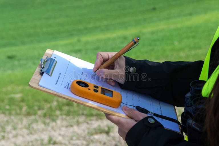 Engineer Writing Notes about Wind Energy Measurement on Clipboard Stock ...