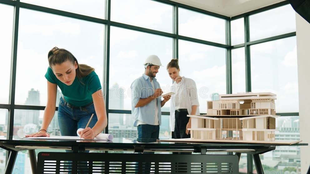 Engineer Write Project Plan while Team Discuss about House Design ...