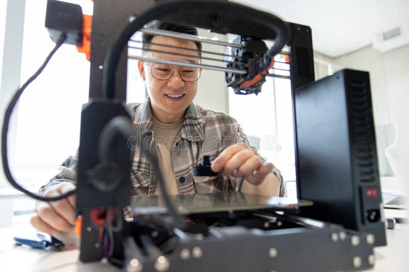 Men Working with 3D Printer and Blueprint for Designing Mechanical ...