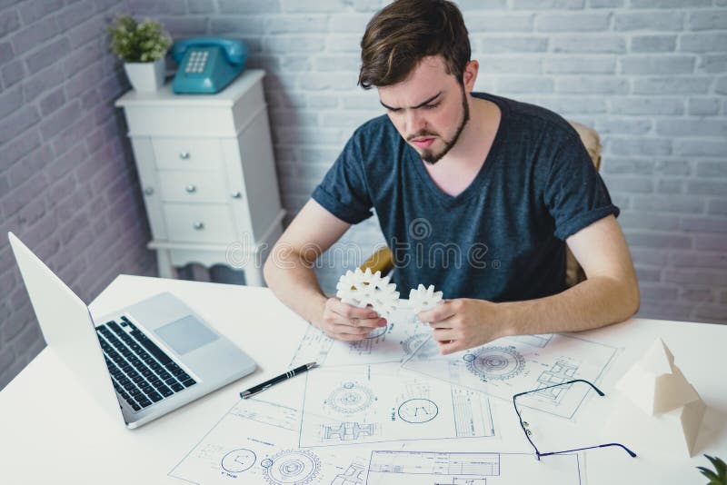 Engineering Man Working on Blueprint for Designing Mechanical Pa Stock ...