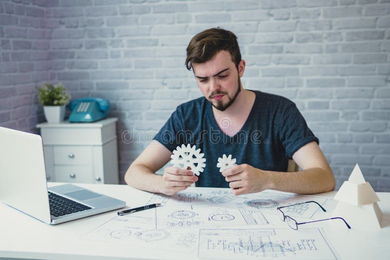 Engineering Man Working on Blueprint for Designing Mechanical Pa Stock ...