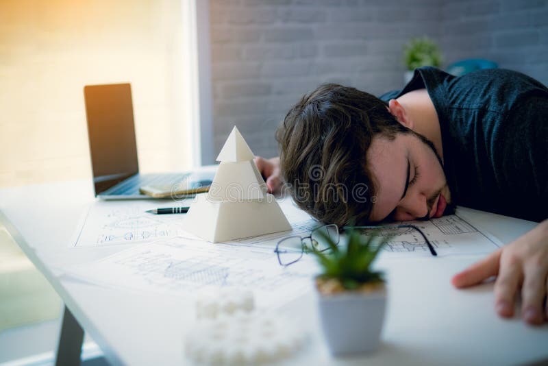 Engineering Man Working Overwork and Sleep on the Desk with Blue Stock ...