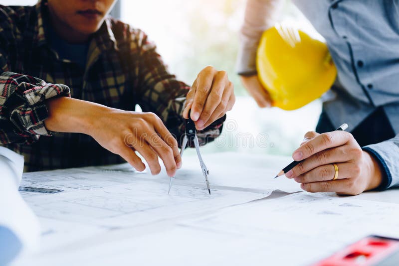 Engineering Partnerships Working with Blueprints and Discussing Project ...