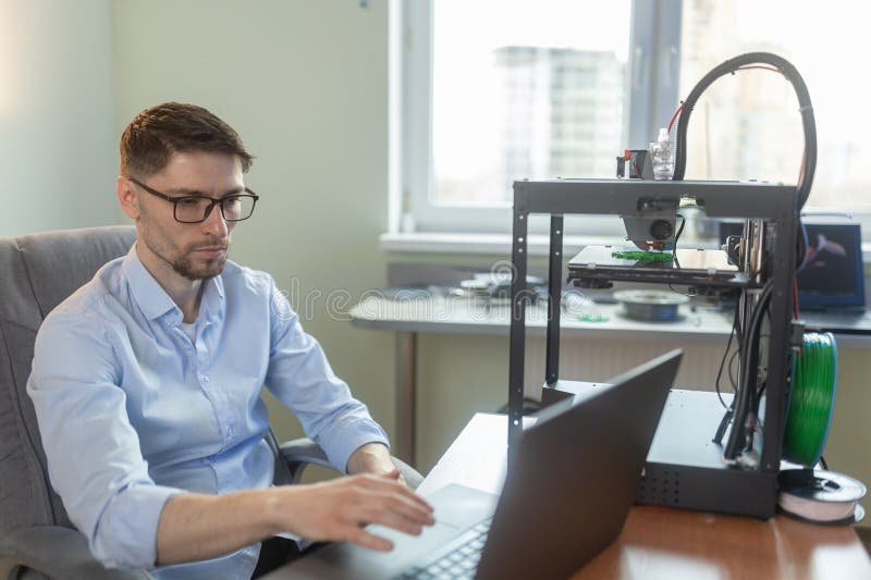 Engineering Student Working in the Lab with a Laptop, 3D Printer in the ...