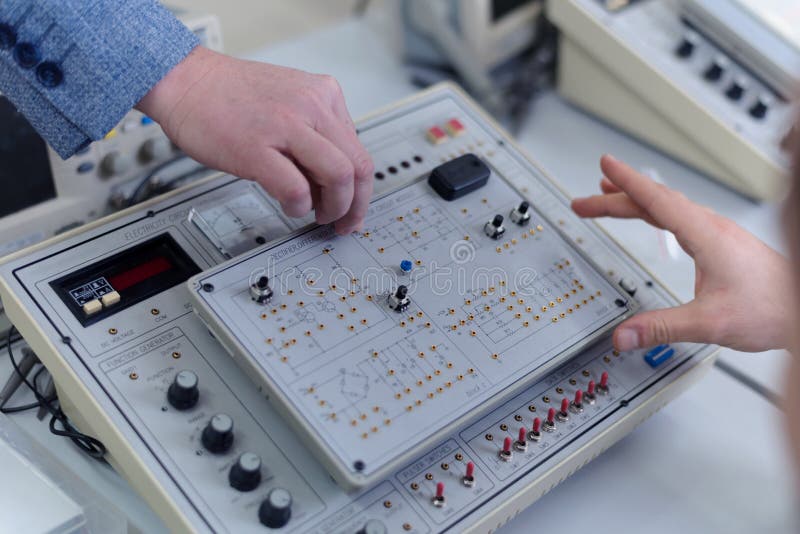 Engineering Students Working in the Lab. Students are Adjusting an ...