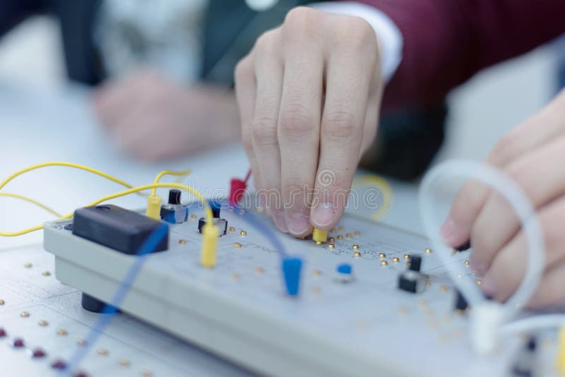 Engineering Students Working in the Lab. Students are Adjusting an ...