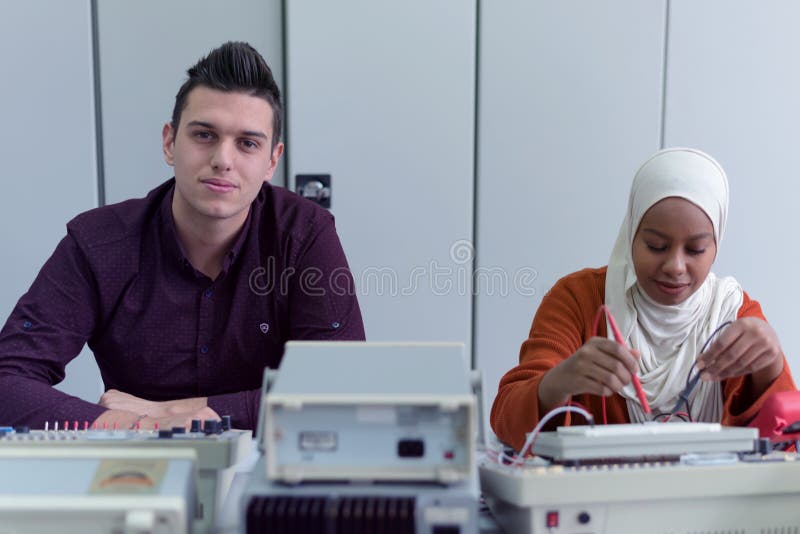 Engineering Students Working in the Lab. Students are Adjusting an ...