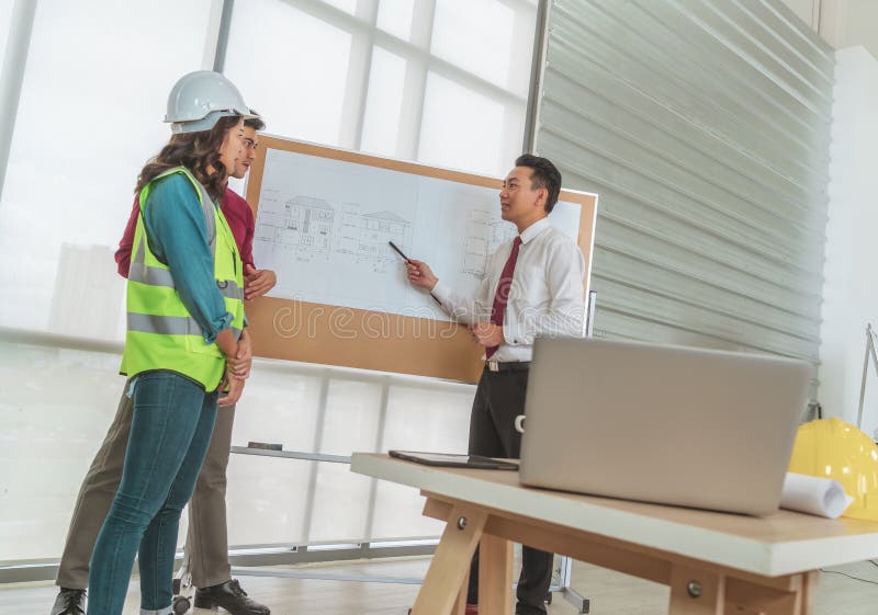 Engineering Team Having a Meeting on Construction Plan in Construction ...