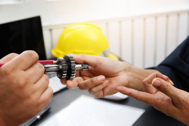 The Engineering Team Point To the Gear and Discussing on Their Project ...