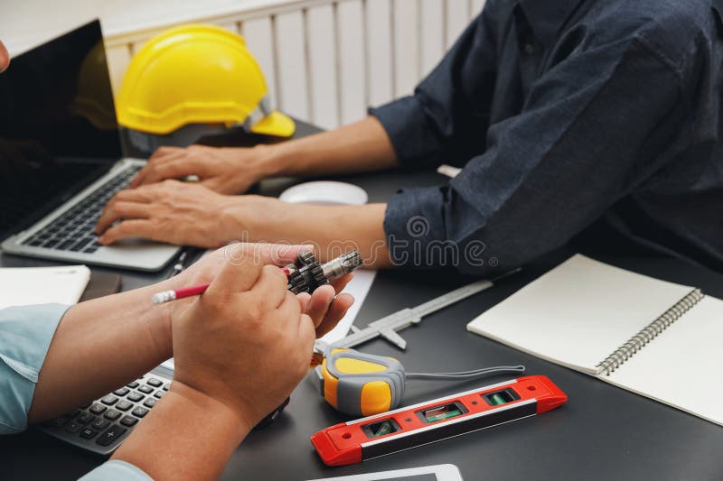 The Engineering Team Point To the Gear and Discussing on Their Project ...