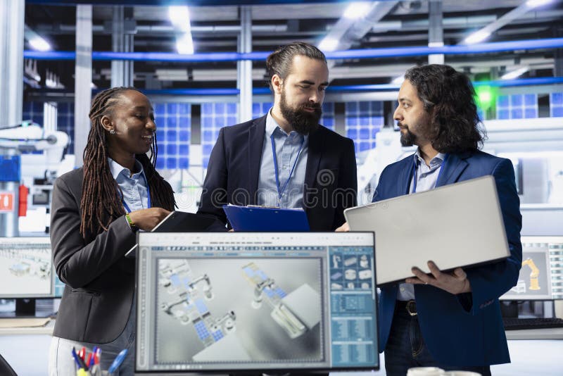 Engineering Team in Solar Panel Plant Adjusting Robotic Machinery ...
