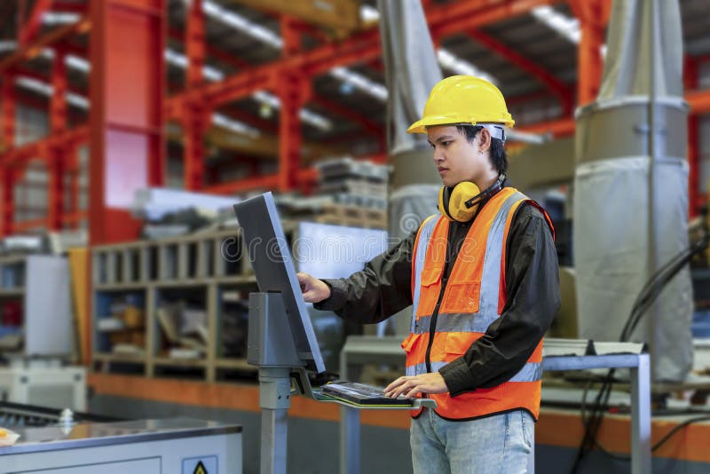 Engineering Technician Worker is Operating the Machine Inside Factory ...