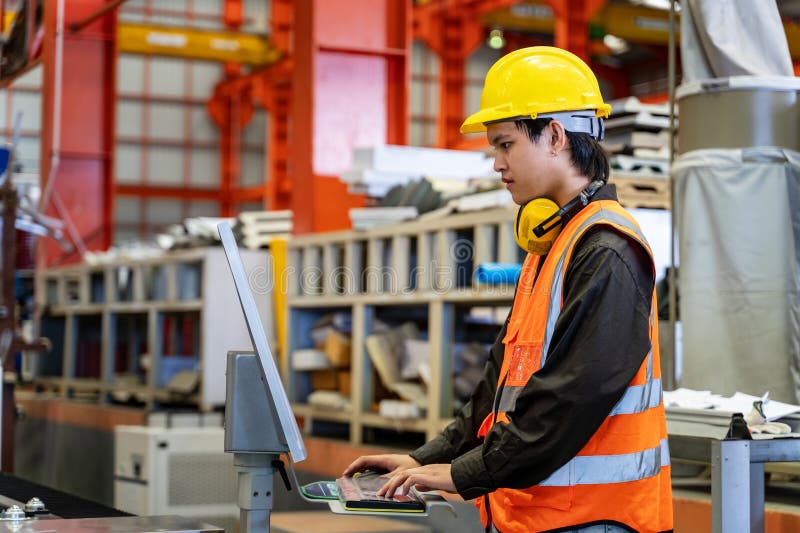 Engineering Technician Worker is Operating the Machine Inside Factory ...