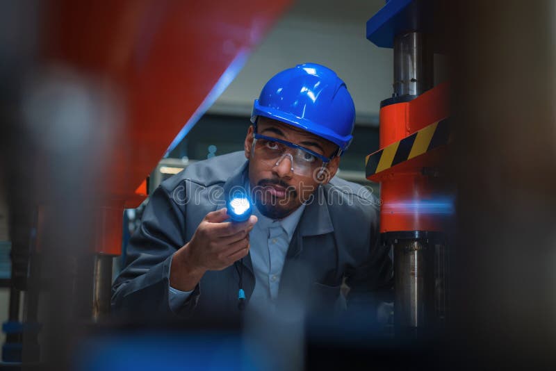Engineering Technology Professional Holding a Flashlight and Checking ...