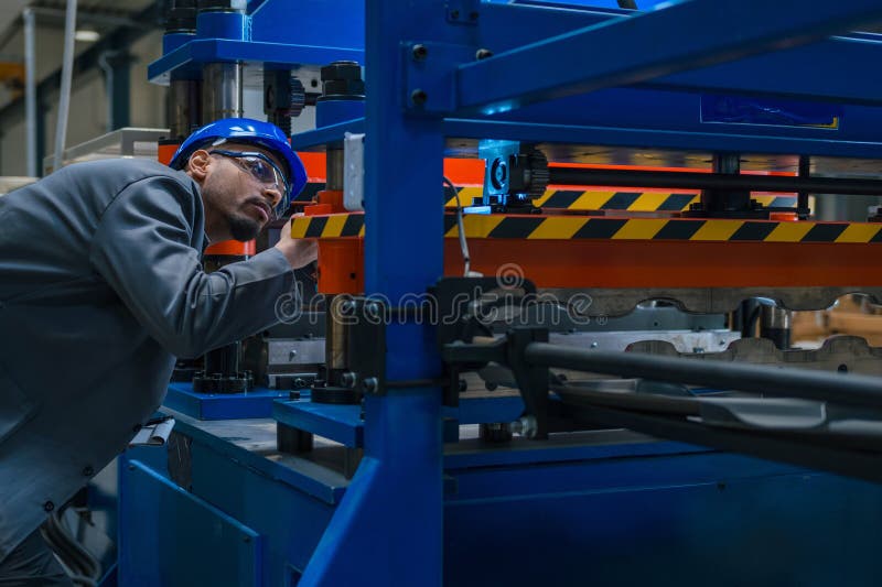 Engineering Technology Professional Holding a Flashlight and Checking ...