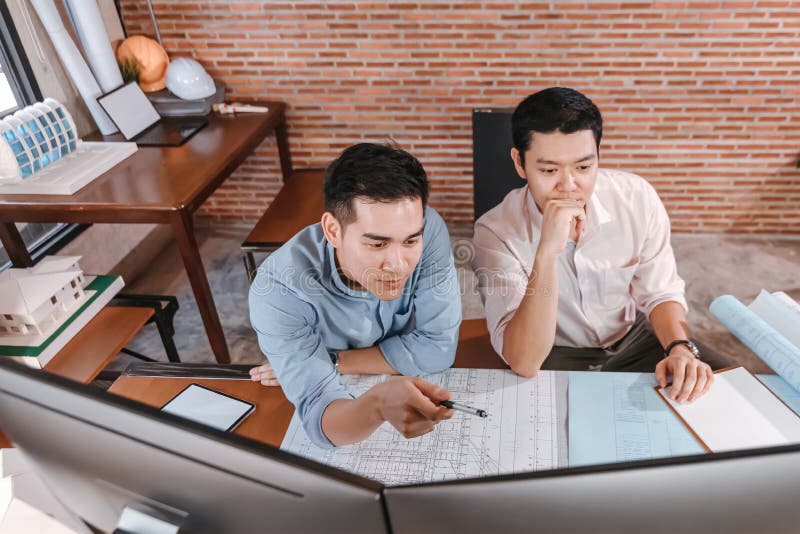 Engineers and Architect Reading a Building and Drawing Outlay ...