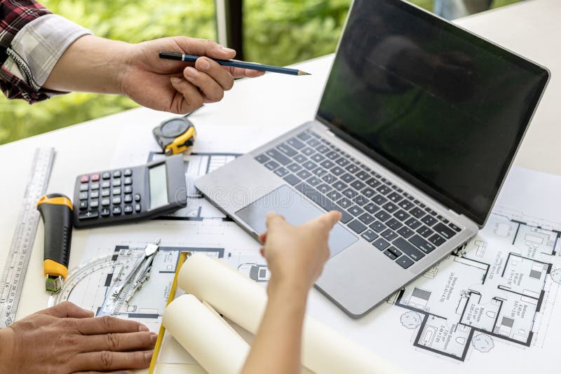 Engineers and Architects Pointing at Laptop Screens Looking at ...