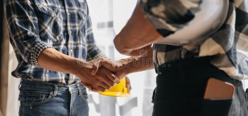 Engineers or Architecture Shaking Hands at Construction Site for ...