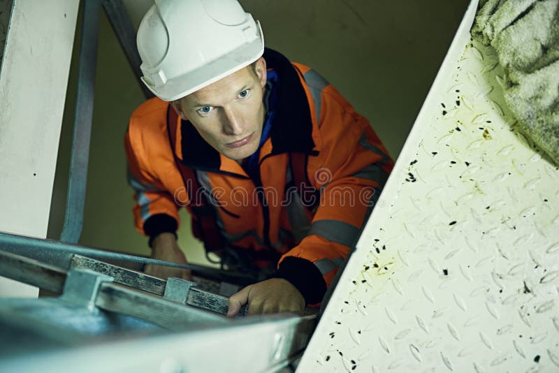Engineers Arent Afraid of Heights. Shot of a Young Engineer in Safety ...
