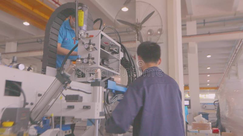 Engineers Assemble Machines at a Large Modern Plant, the Process of ...