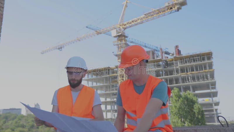 Engineers on the Background of the Construction Site. Builders on the ...
