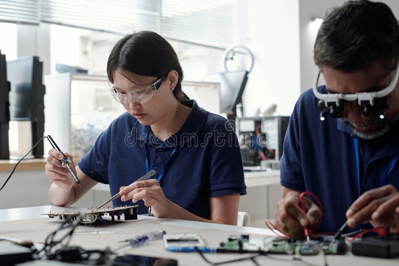 Workers Creating Technological Devices in Office Setting Stock Image ...