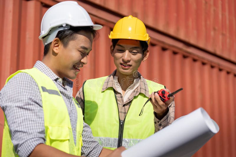 Engineers Discussing Logistics and Construction Plans with Blueprints ...