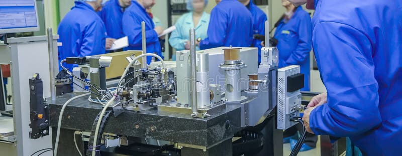 Engineers Collaborate on Machine Assembly in a Modern Workshop during a ...