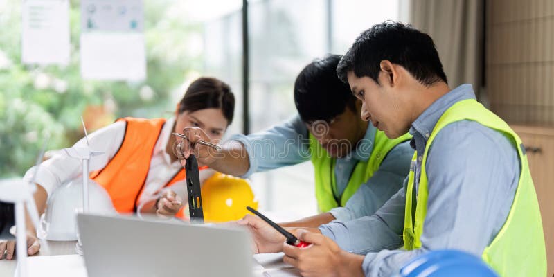 Green Tech and Engineering Collaboration. Engineers Working on ...