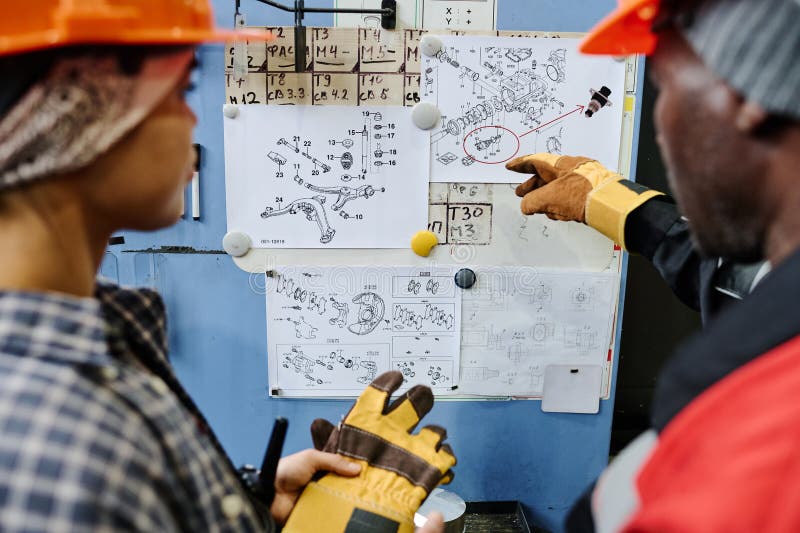 Engineers Collaborating on Mechanical Blueprints Stock Photo - Image of ...