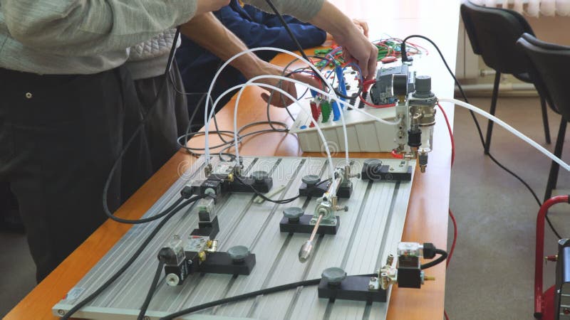 Engineers Connect Wires Control Panel with Small Test Bench for ...