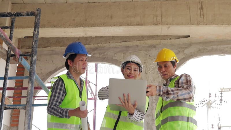 Engineers and Construction Contractors Holding a Laptop To Discuss ...