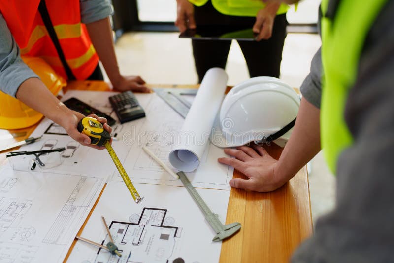 Engineers Discuss Building on Blueprint Drawing, Design Building ...